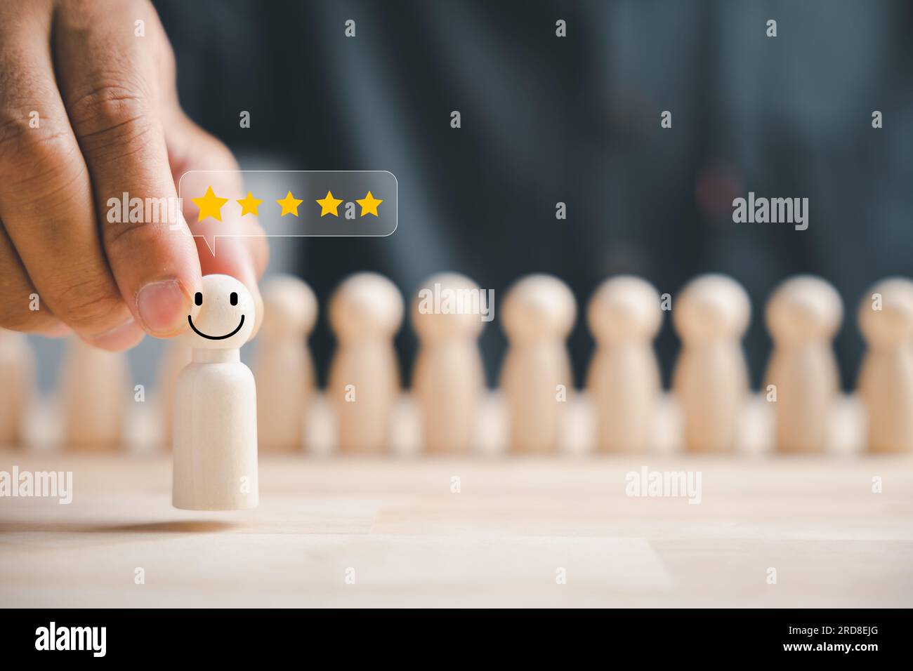 Hand choosing a wooden figure as the chosen leader from the crowd Stock ...