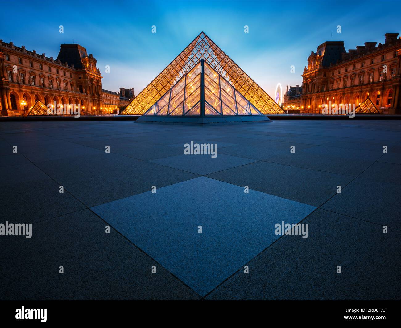 The Louvre museum located in Paris, France during twilight with long ...