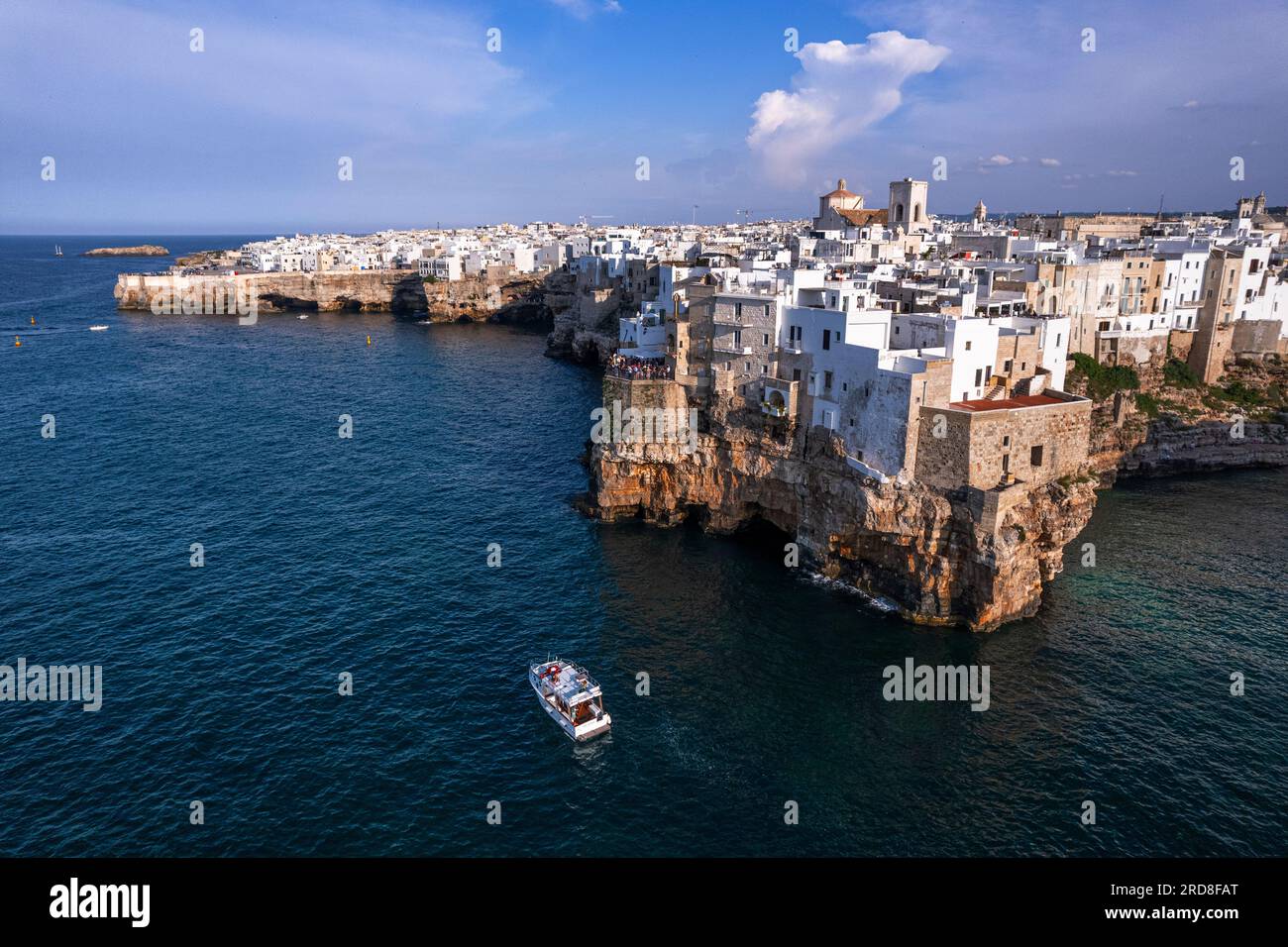 Aerial view of a boat sailing off the coast of Polignano a Mare fishing ...