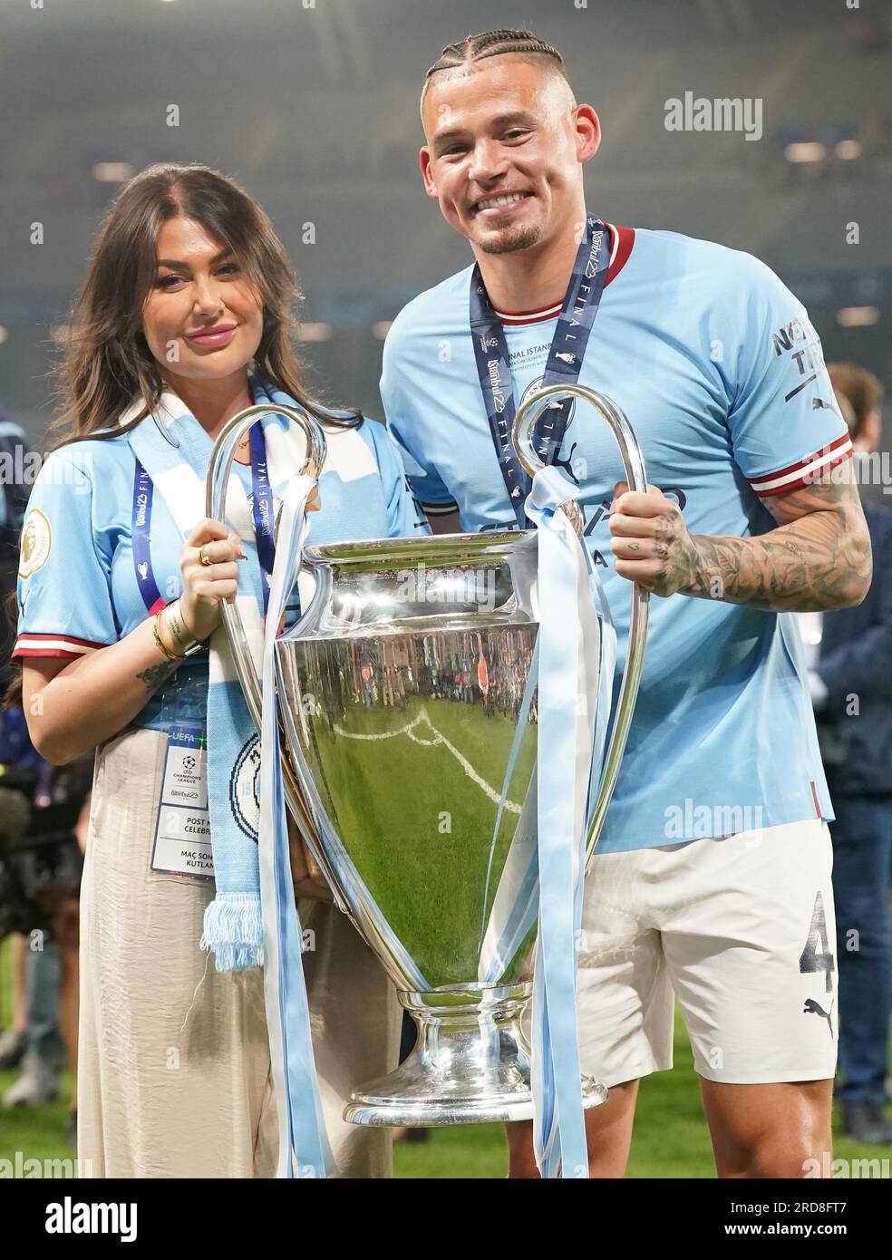 Manchester City's Kalvin Phillips holds the Champions League trophy ...