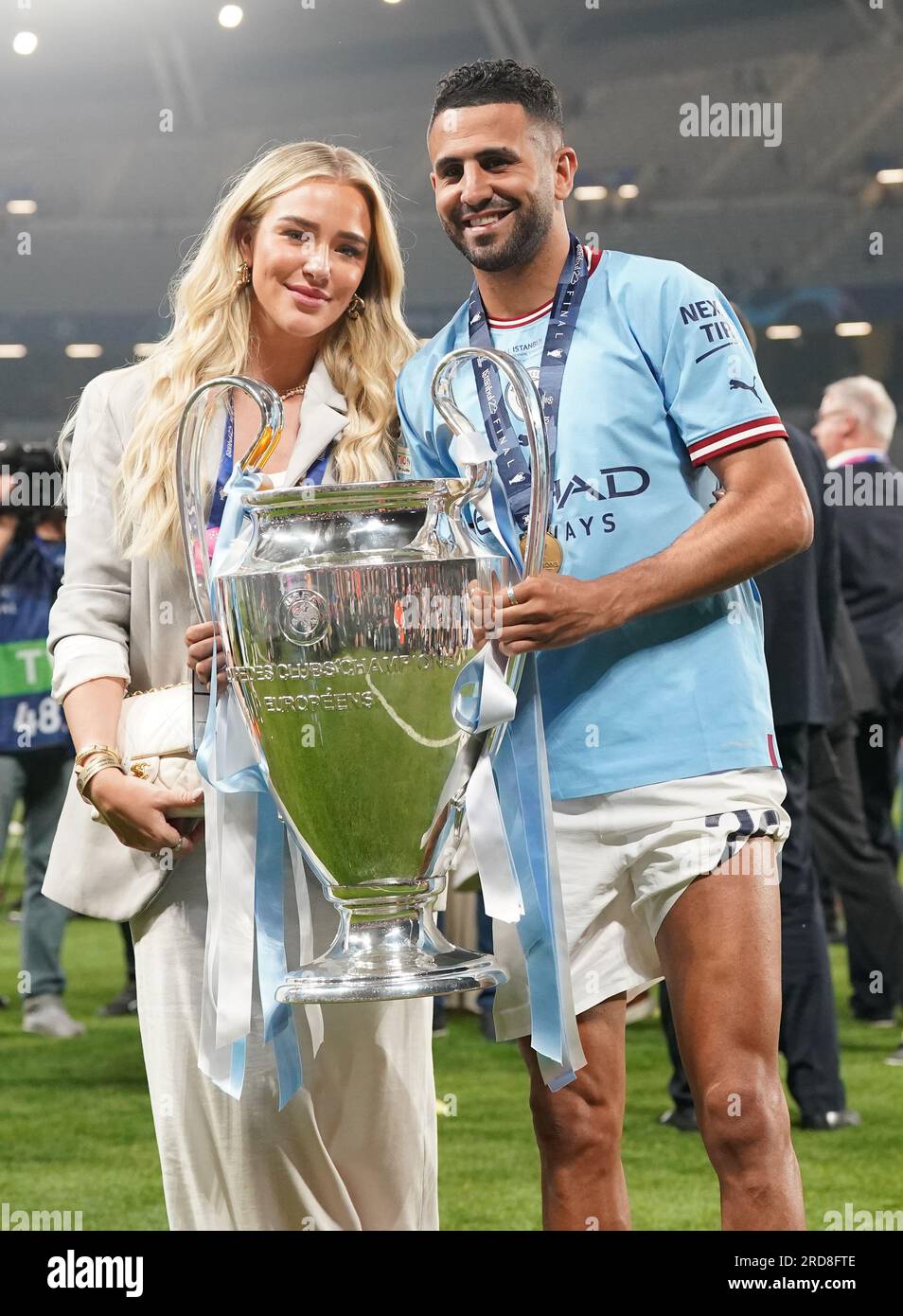 Manchester City's Riyad Mahrez holds the Champions League trophy with ...