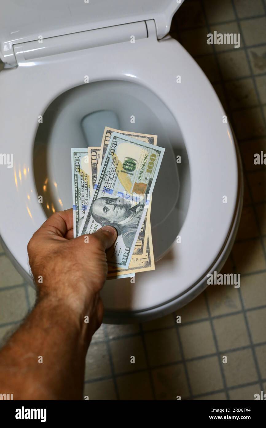 Flushing away money concept - toilet bowl Stock Photo - Alamy