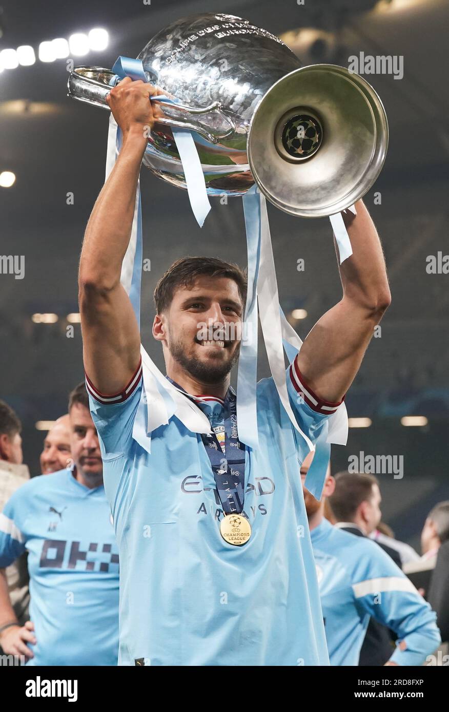 Manchester City's Ruben Dias holds the Champions League trophy as he ...