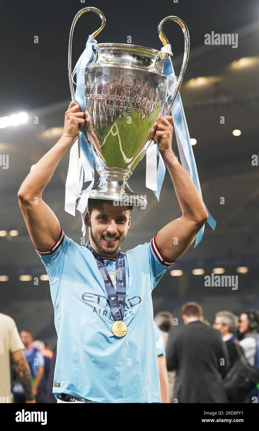 Manchester City's Ruben Dias holds the Champions League trophy as he ...