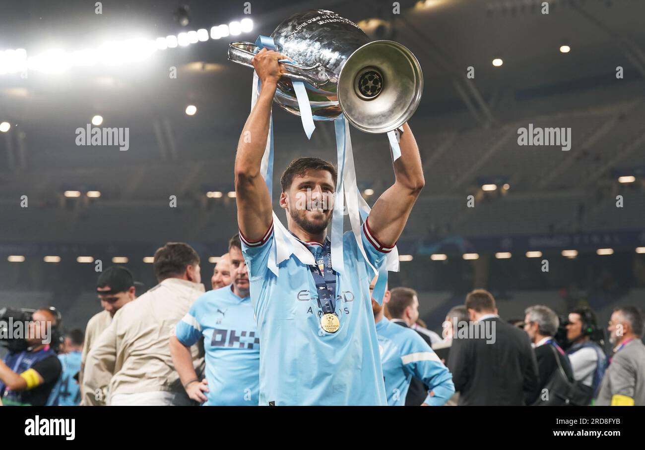 Manchester City's Ruben Dias holds the Champions League trophy as he ...