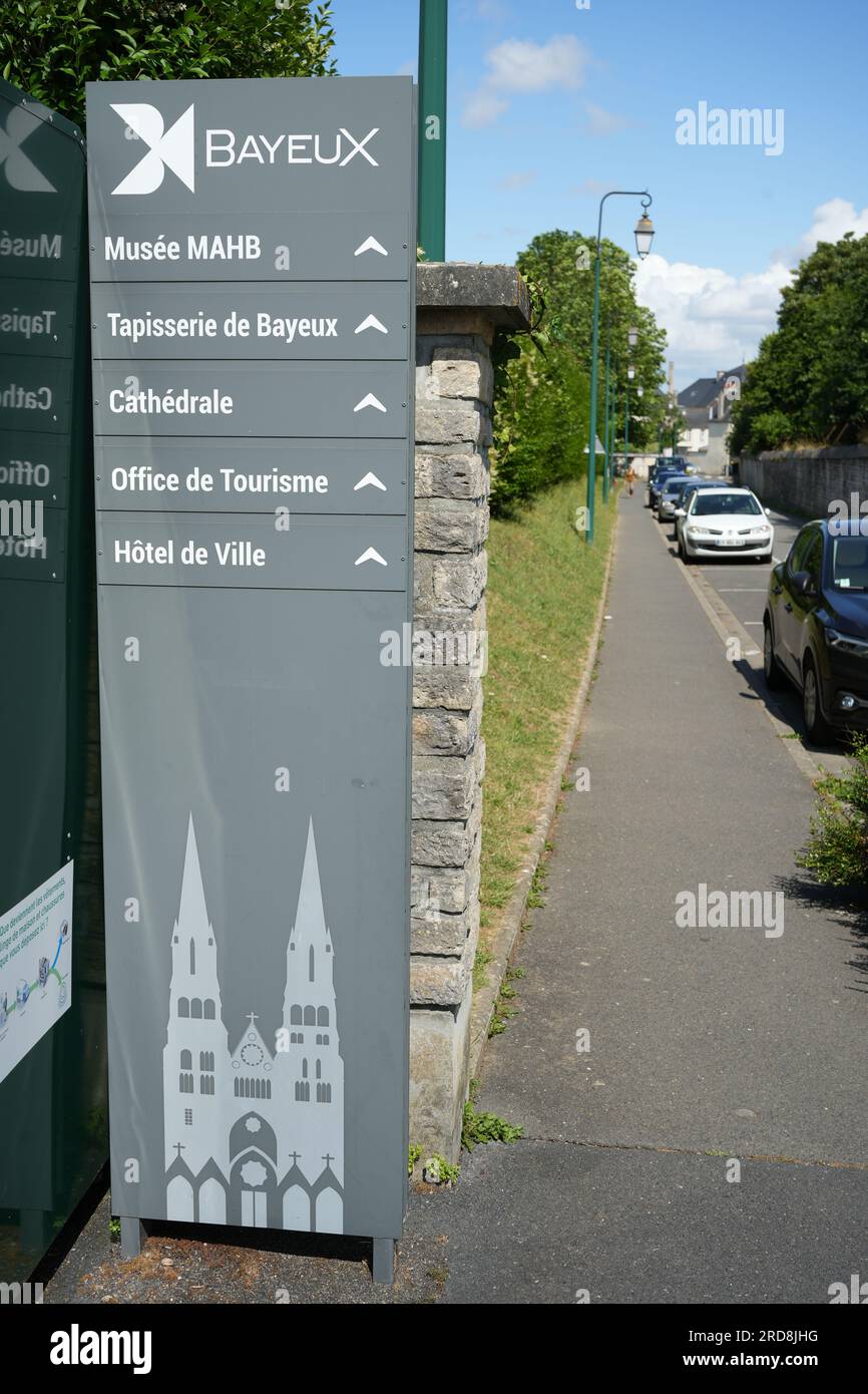 Tourist Street Sign with street behind with green street lights. Bayeux ...