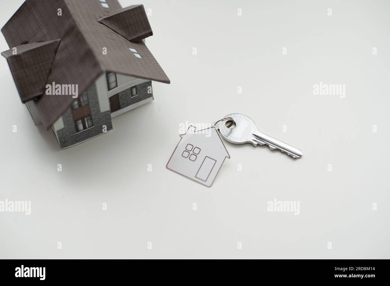 key chain with house symbol and keys on white background,Real estate ...