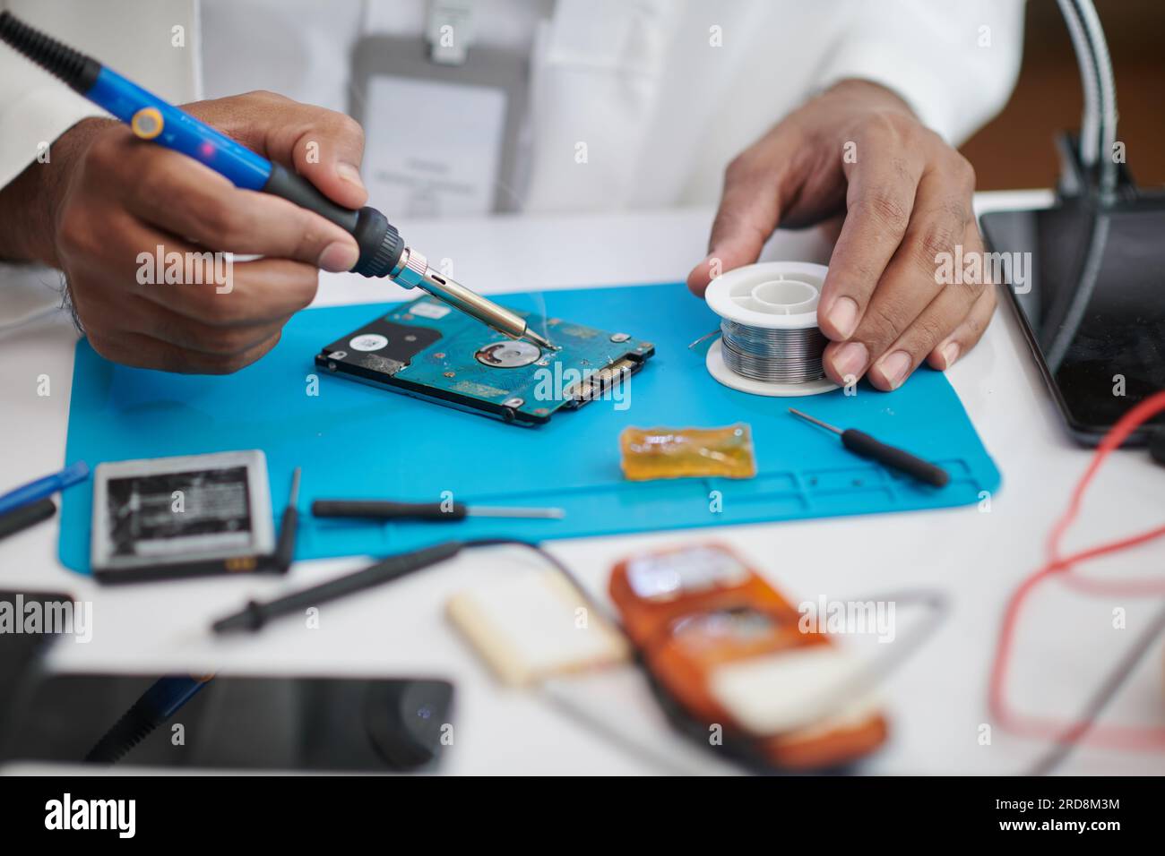 Closeup image of technician soldering computer hard drive Stock Photo ...