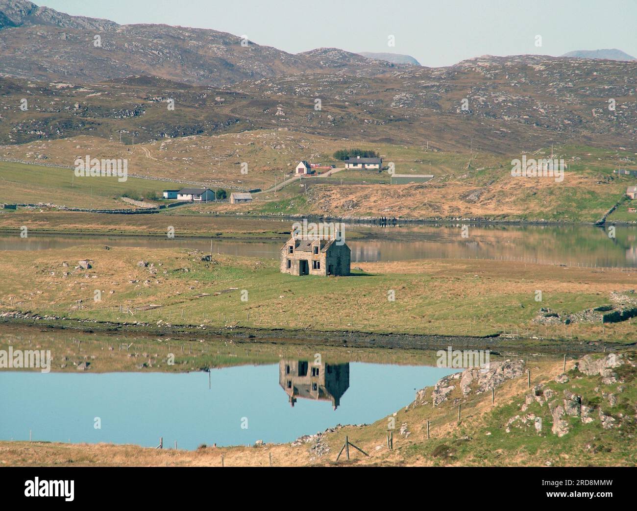 Reflection of an abandoned ruined cottage in the tranquil waters of ...