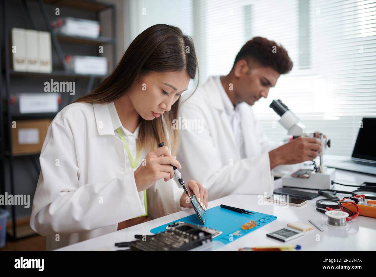 Repairing service workers concentrated on disassembling electronic ...
