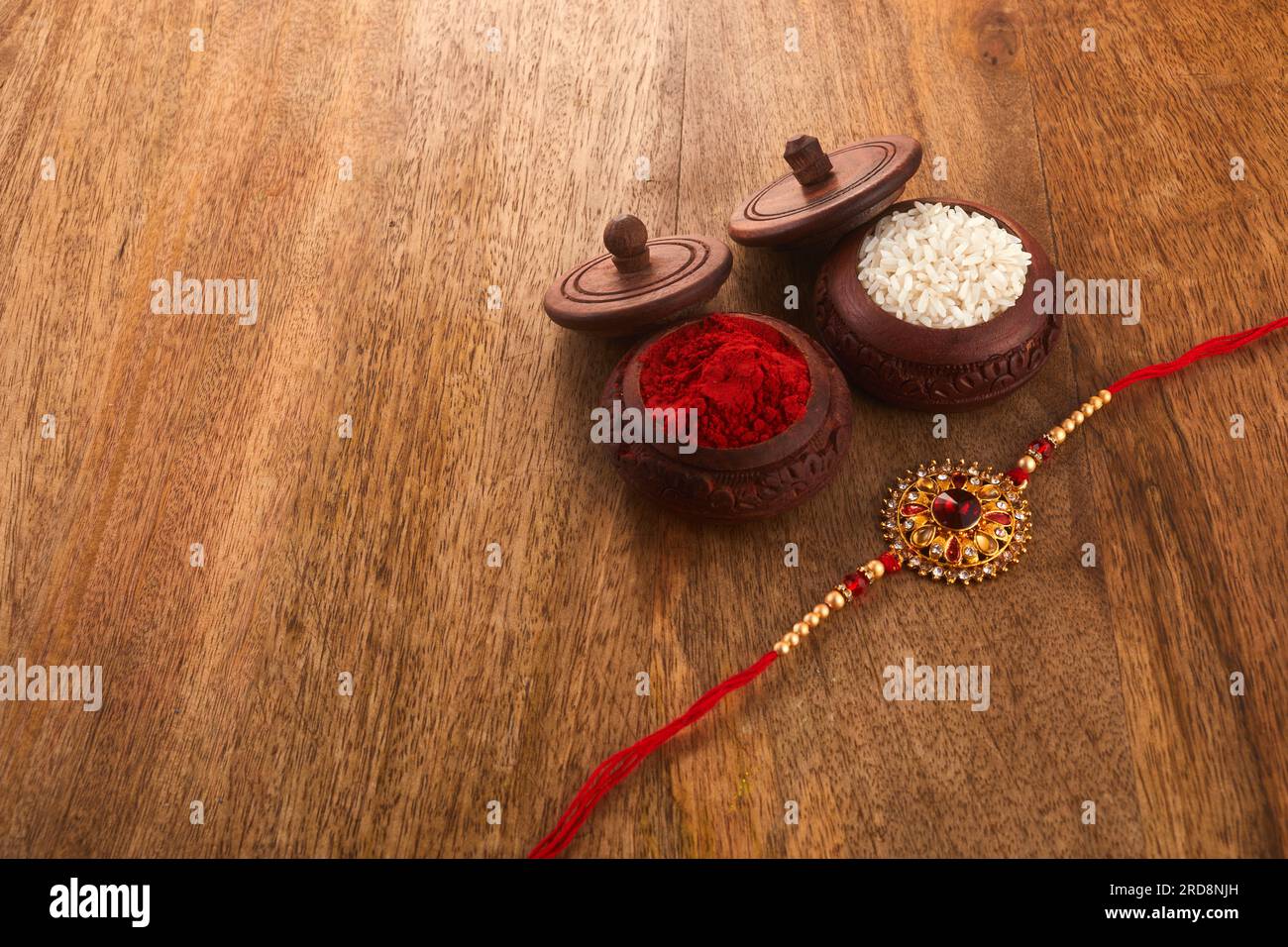 Raksha Bandhan background with Rakhi string, Rice Grains and Kumkum ...