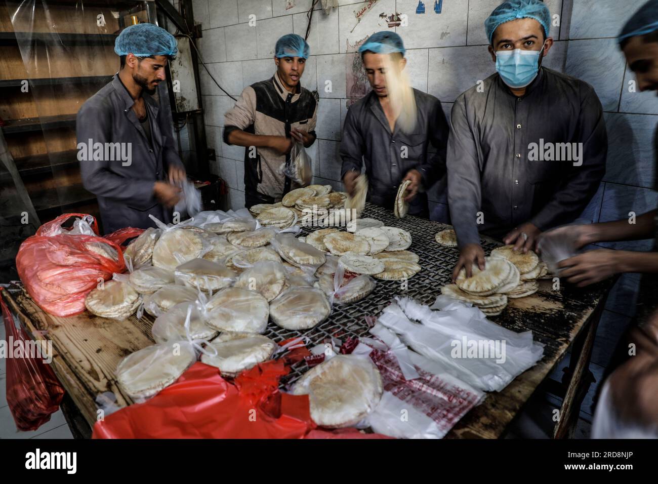 Sanaa, Yemen. 19th July, 2023. Yemeni bakers prepare bread at a bakery ...