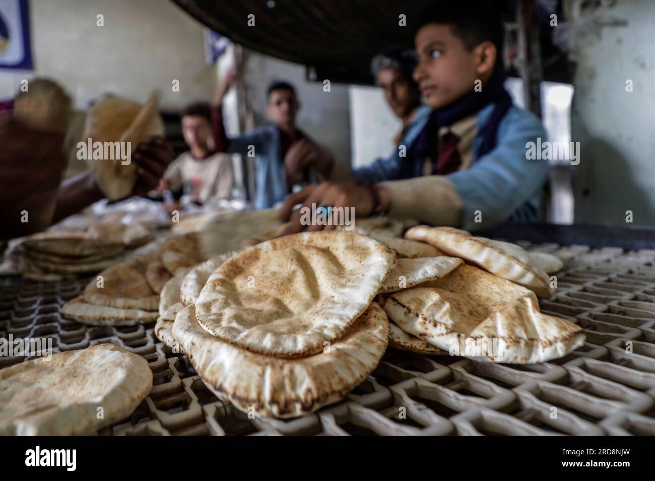 Sanaa, Yemen. 19th July, 2023. Yemeni bakers prepare bread at a bakery ...