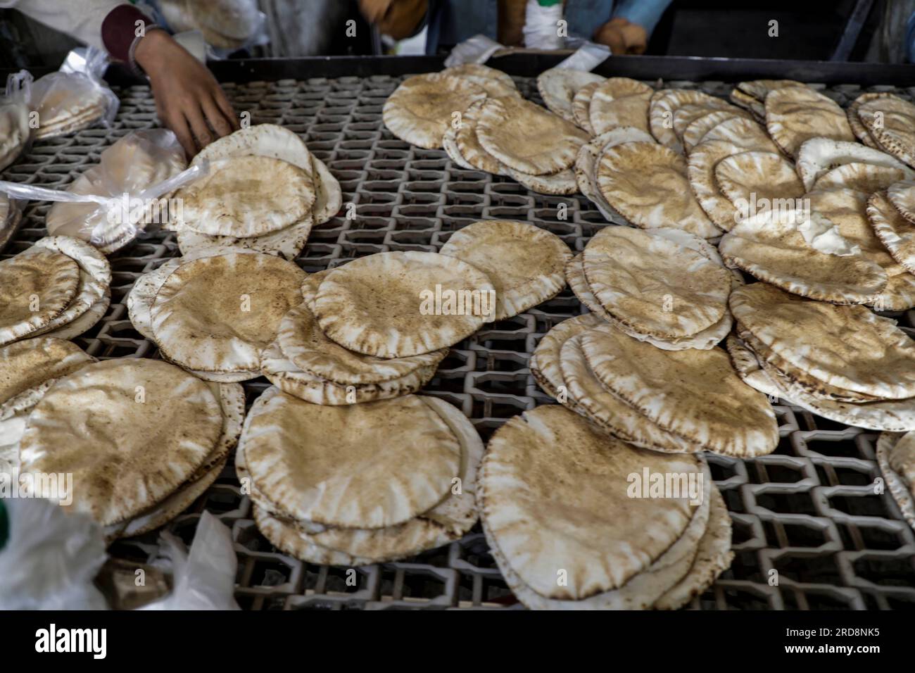 Sanaa, Yemen. 19th July, 2023. Yemeni bakers prepare bread at a bakery ...