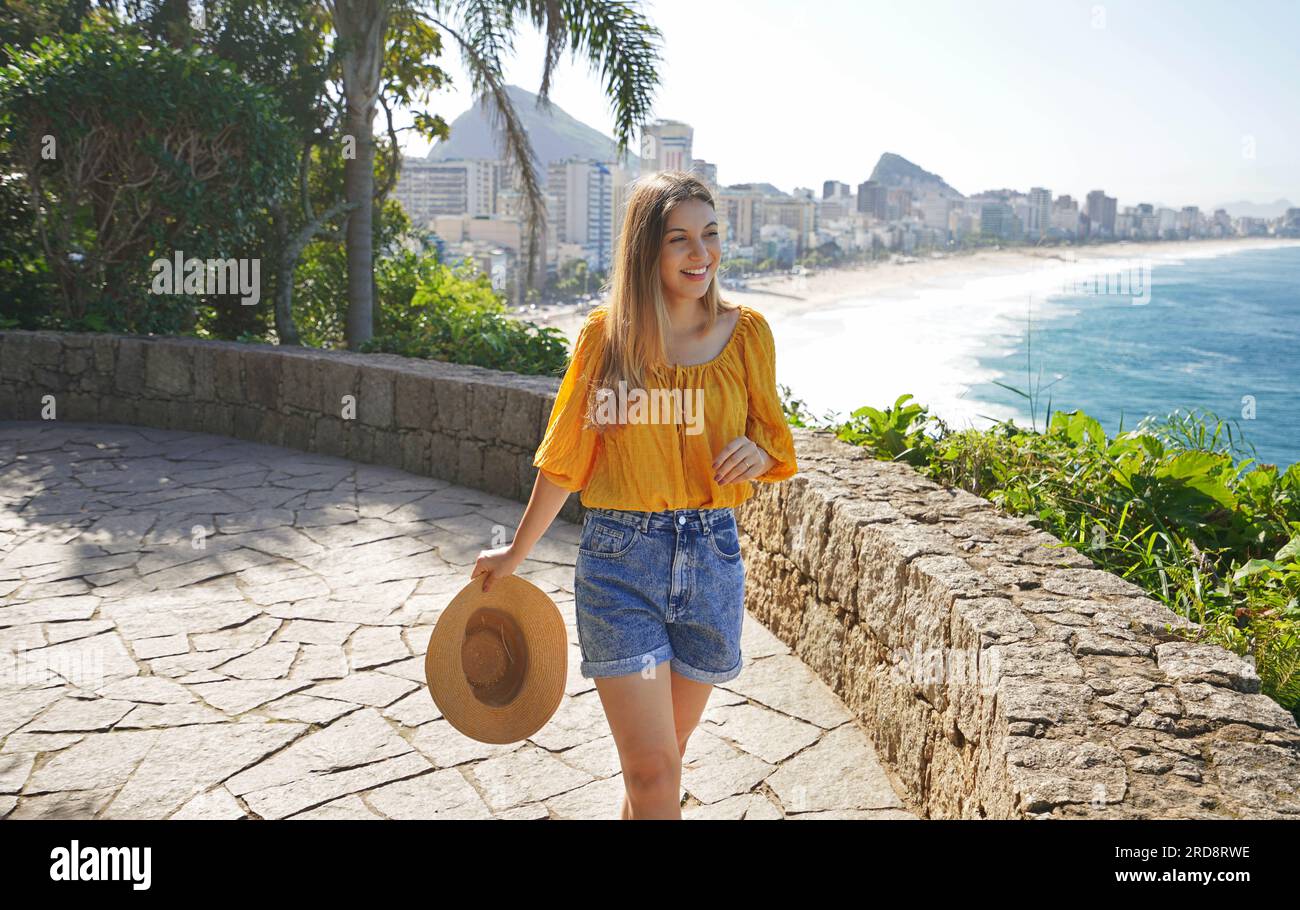 Portrait of smiling tourist woman walking on lookout in Rio de Janeiro ...