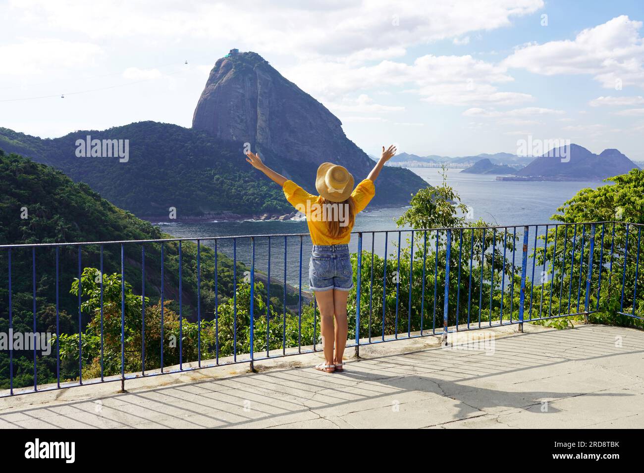 Tourism in Rio de Janeiro. Beautiful grateful traveler girl raising ...
