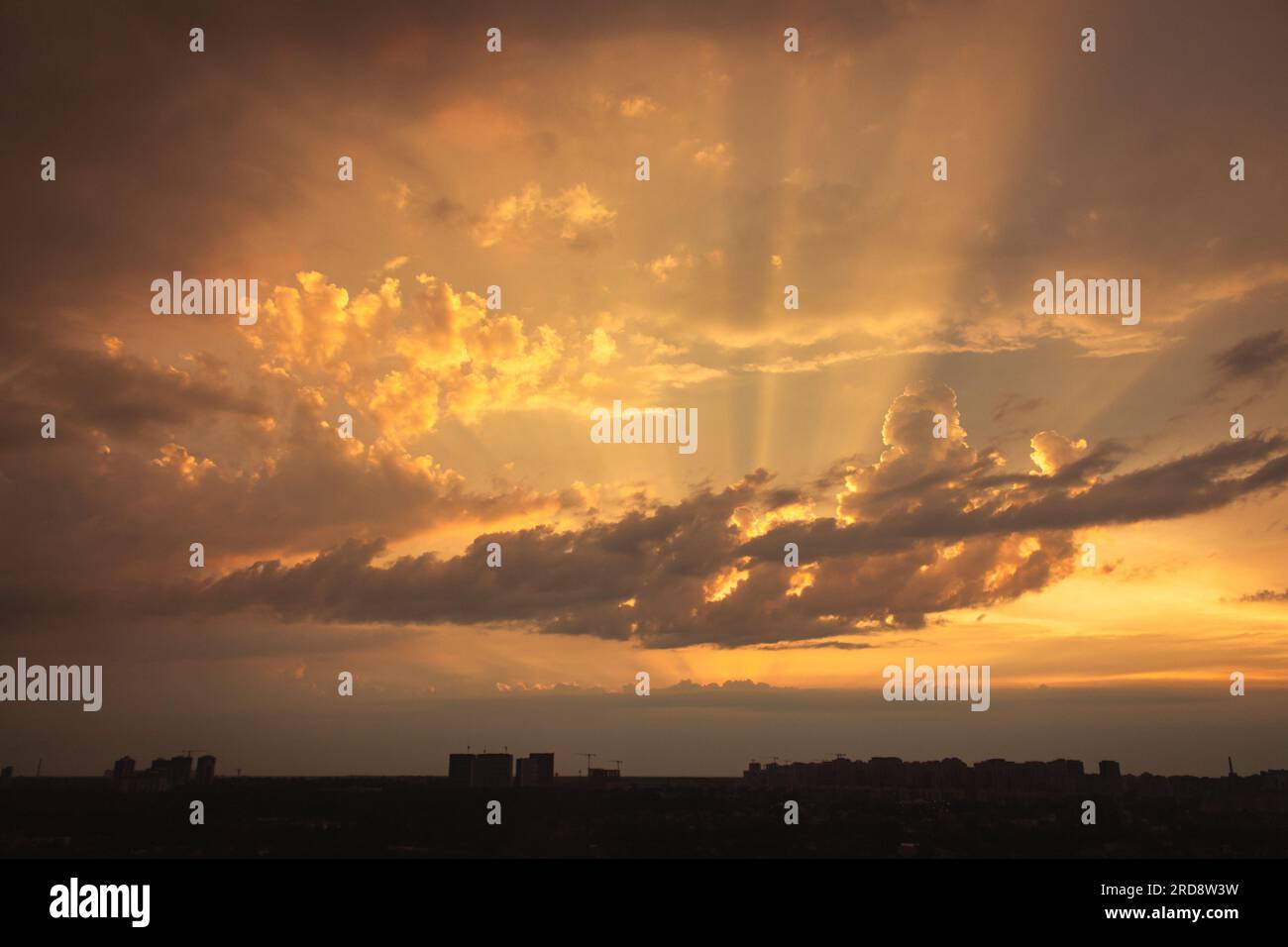 Dramatic evening sky with rays of light over city. Aerial view above ...
