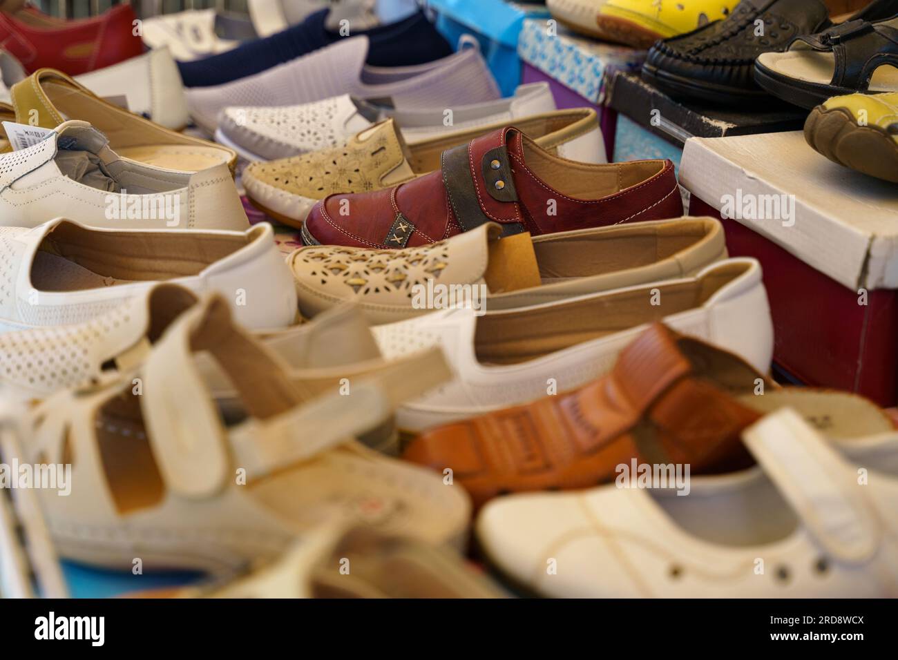 A collection of summer women's shoes is on display in the shop window ...