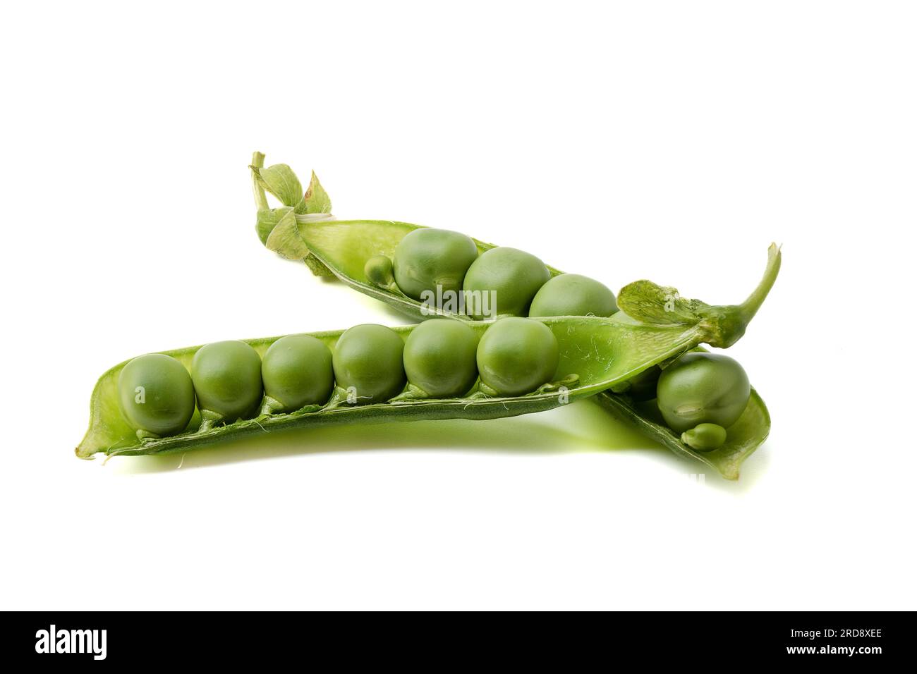 Two open halves of pea pods with peas on a white background. Copy space ...