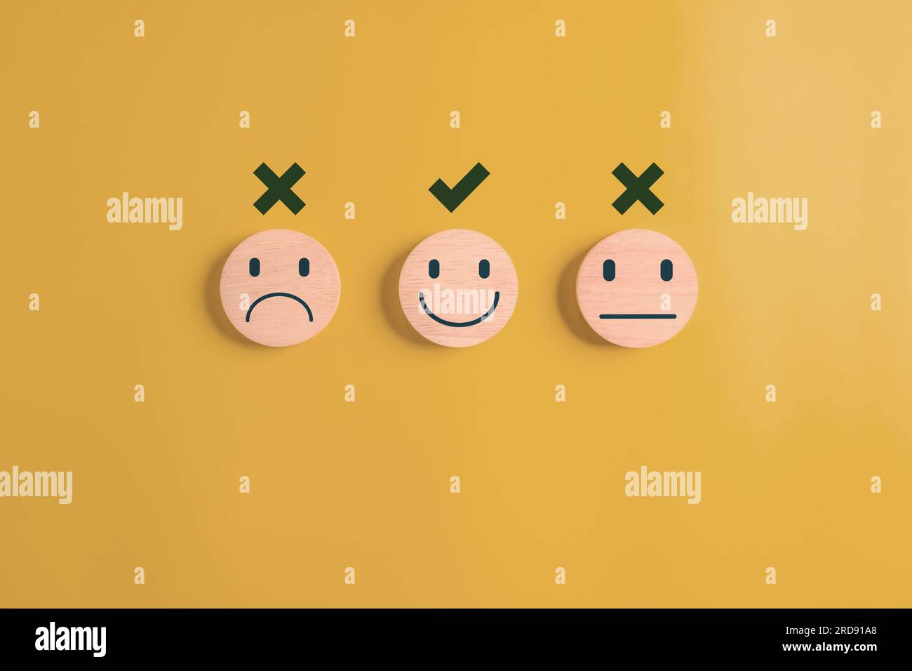 satisfaction with smiley face emoticon on wooden yellow background ...