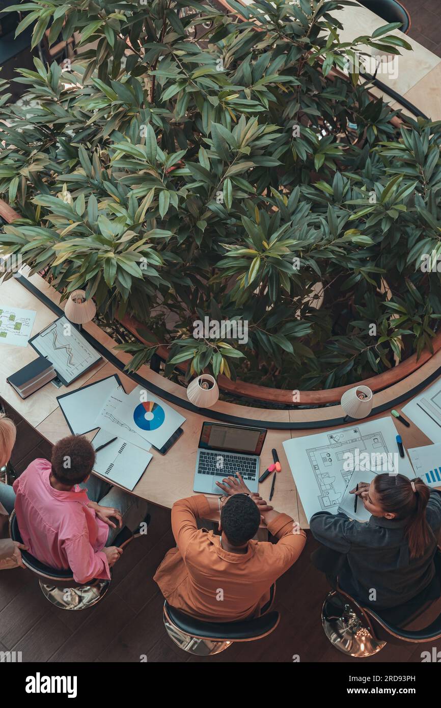 Group of coworkers working together and talking at modern office ...