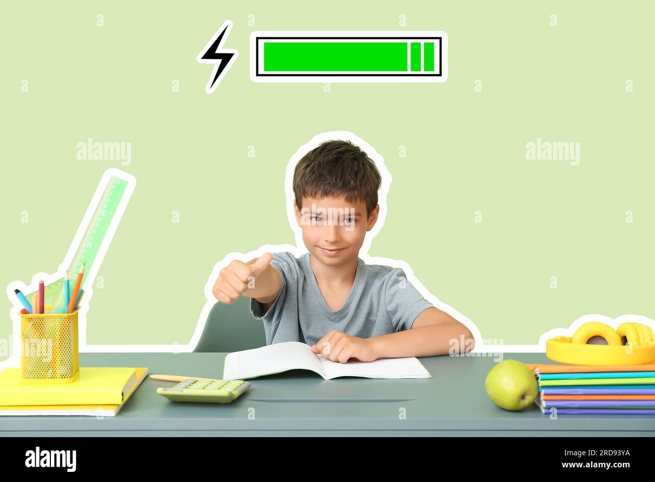 Smart little boy doing homework at table against green background Stock ...