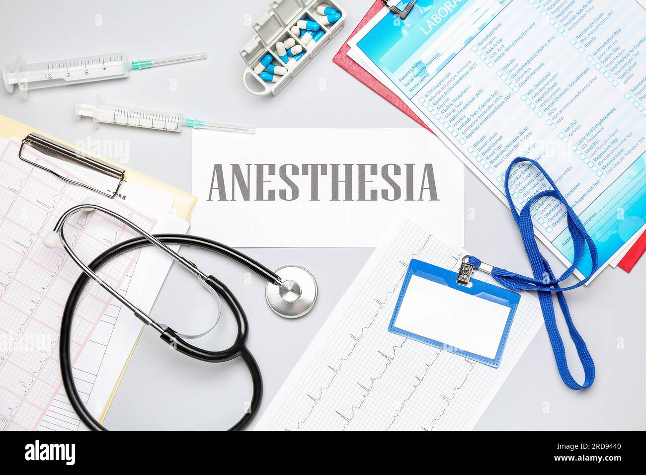 Paper with word ANESTHESIA and medical supplies on light background ...