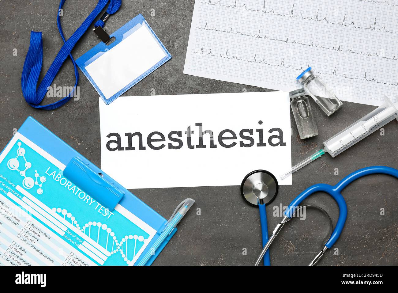 Paper with word ANESTHESIA and medical supplies on dark background ...