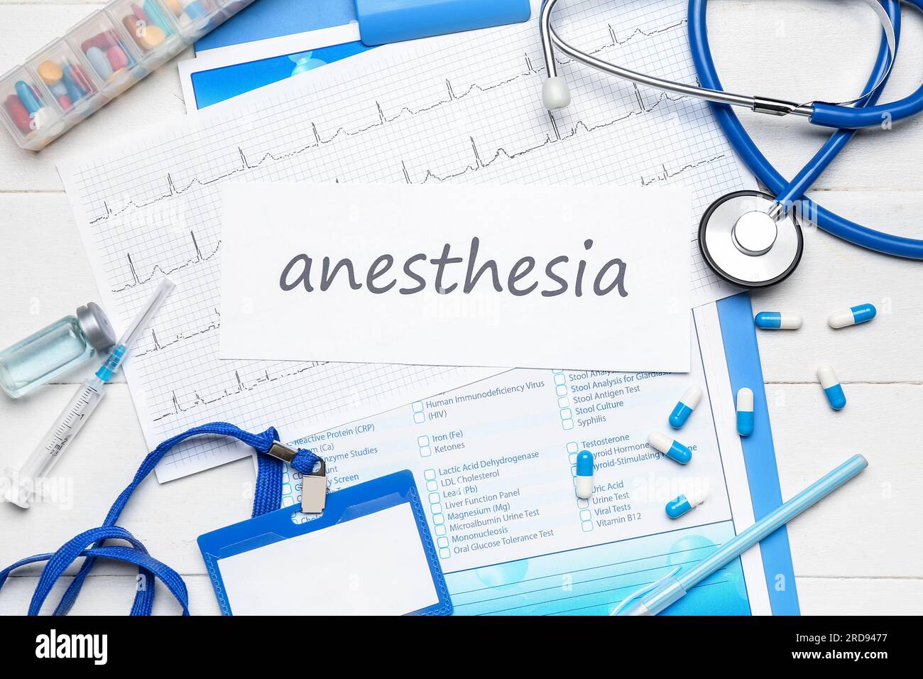 Clipboard with word ANESTHESIA and medical supplies on white wooden ...