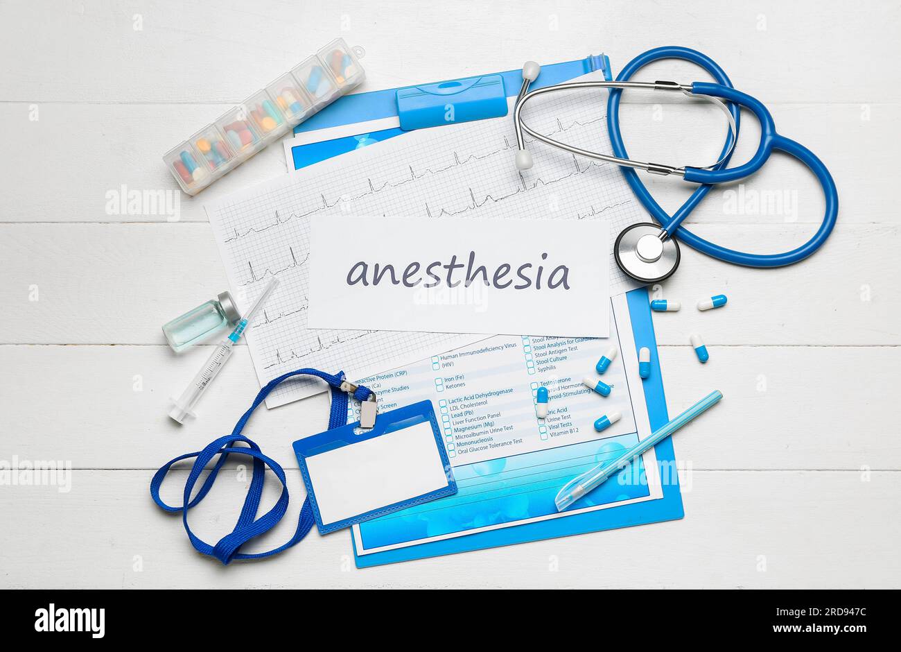 Clipboard with word ANESTHESIA and medical supplies on white wooden ...