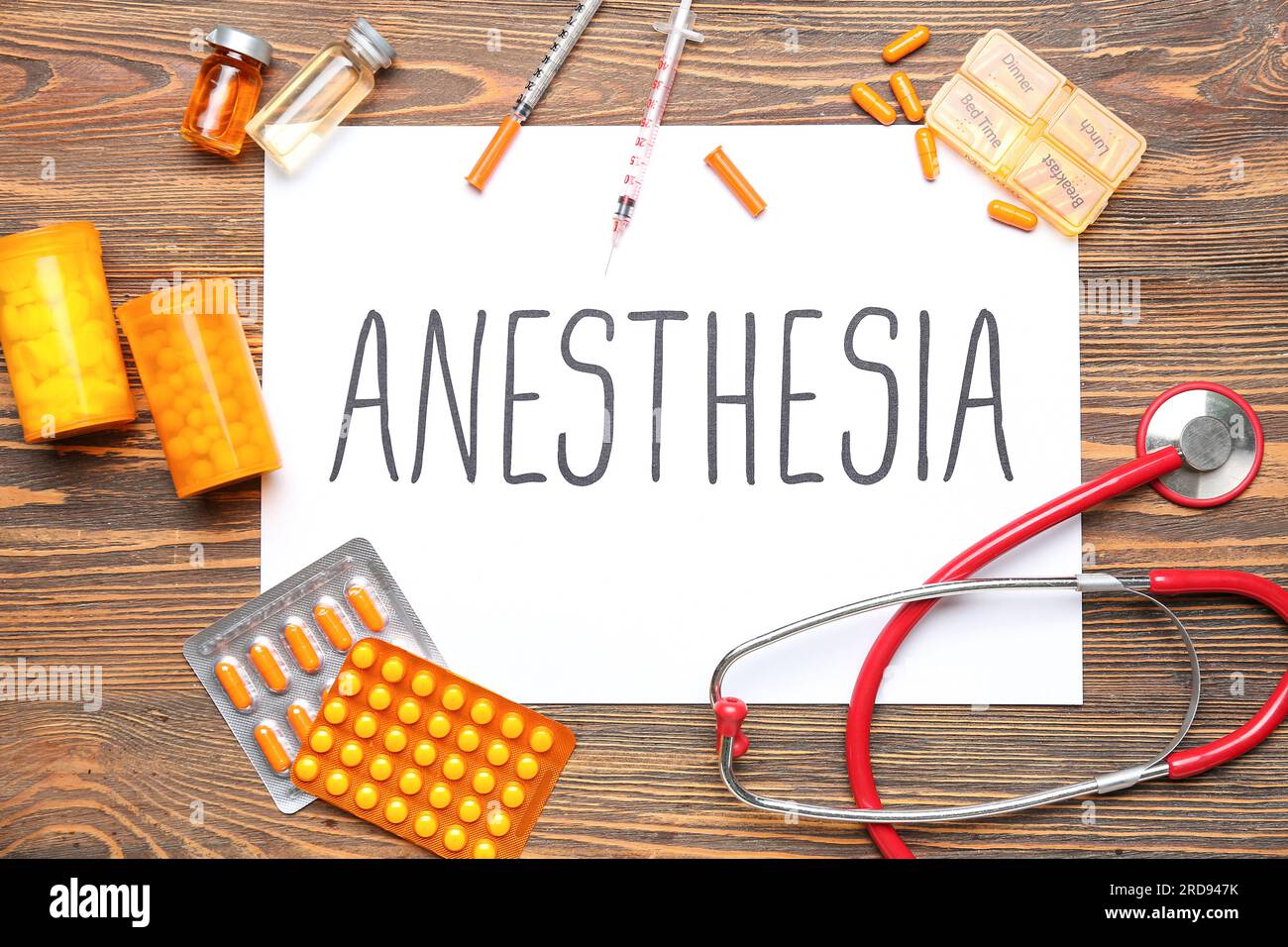 Paper with word ANESTHESIA and medical supplies on wooden background ...