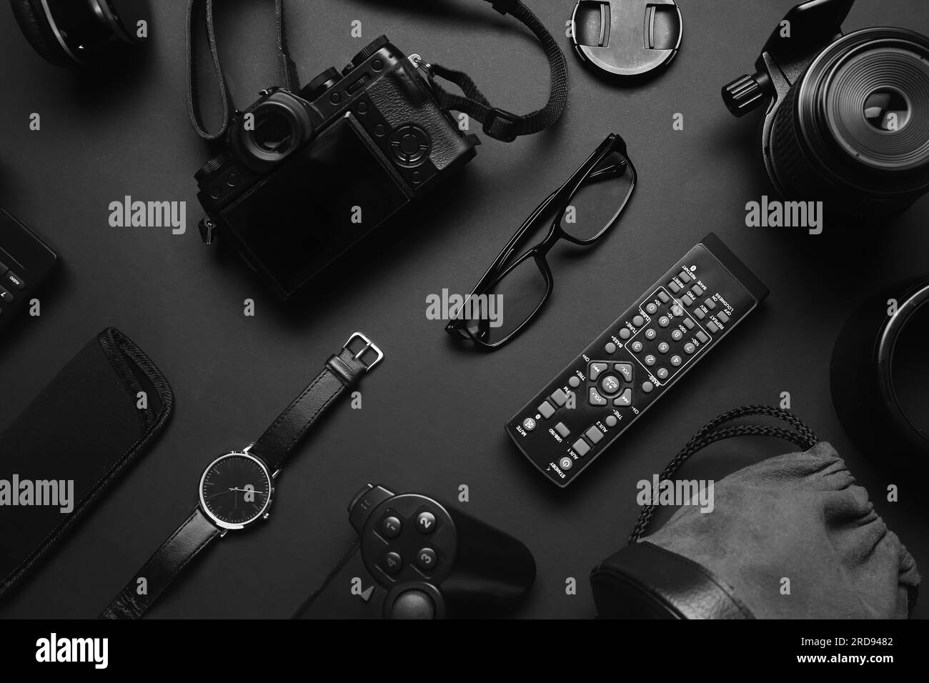 Composition with modern gadgets, eyeglasses and wristwatch on dark ...