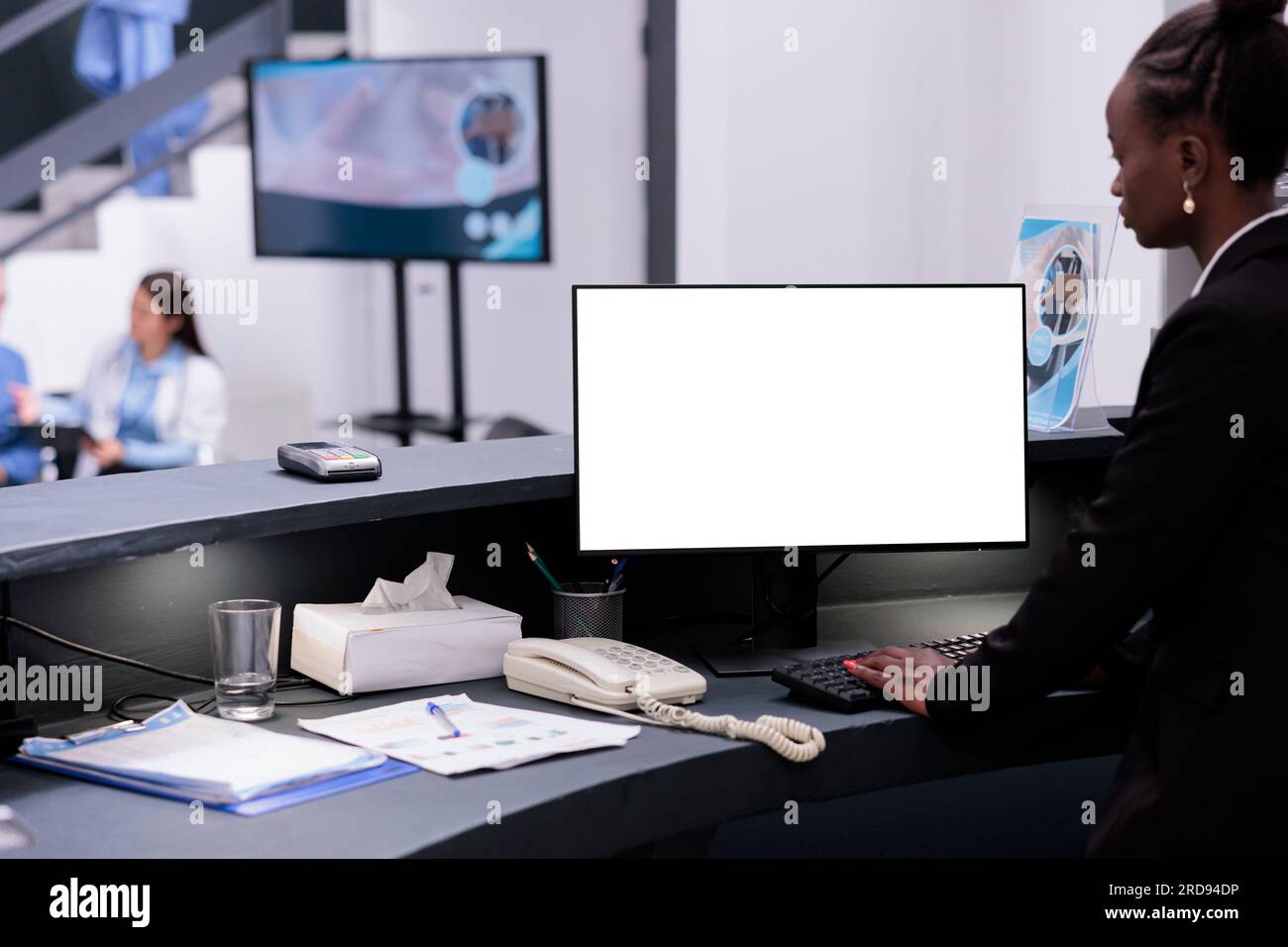 African american receptionist using white isolated screen on computer ...