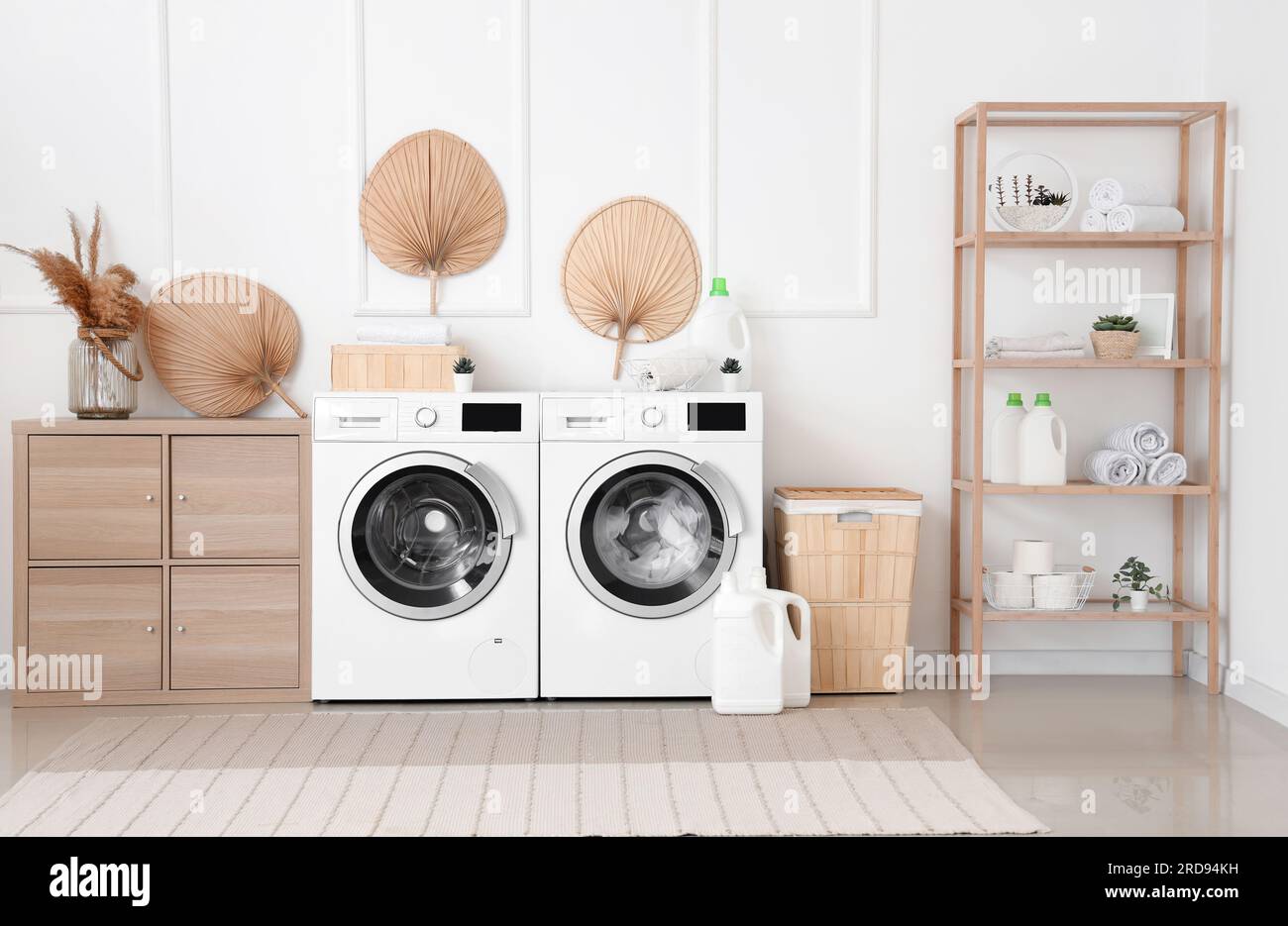 Interior of laundry room with washing machines, wooden cabinet and ...