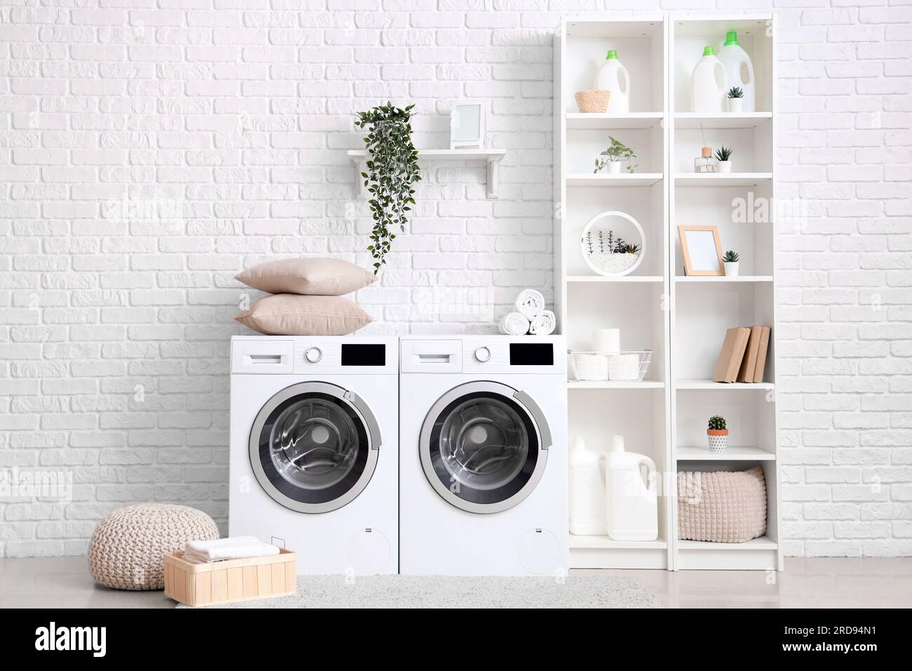 Interior of laundry room with washing machines and shelving unit Stock ...