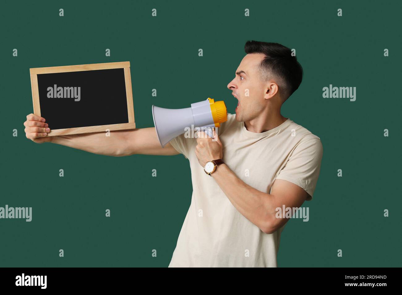 Male teacher with chalkboard shouting into megaphone on green ...