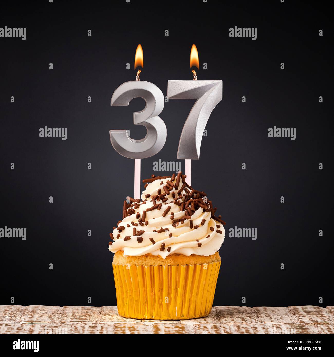 Birthday candle number 37 - Anniversary cupcake on black background ...