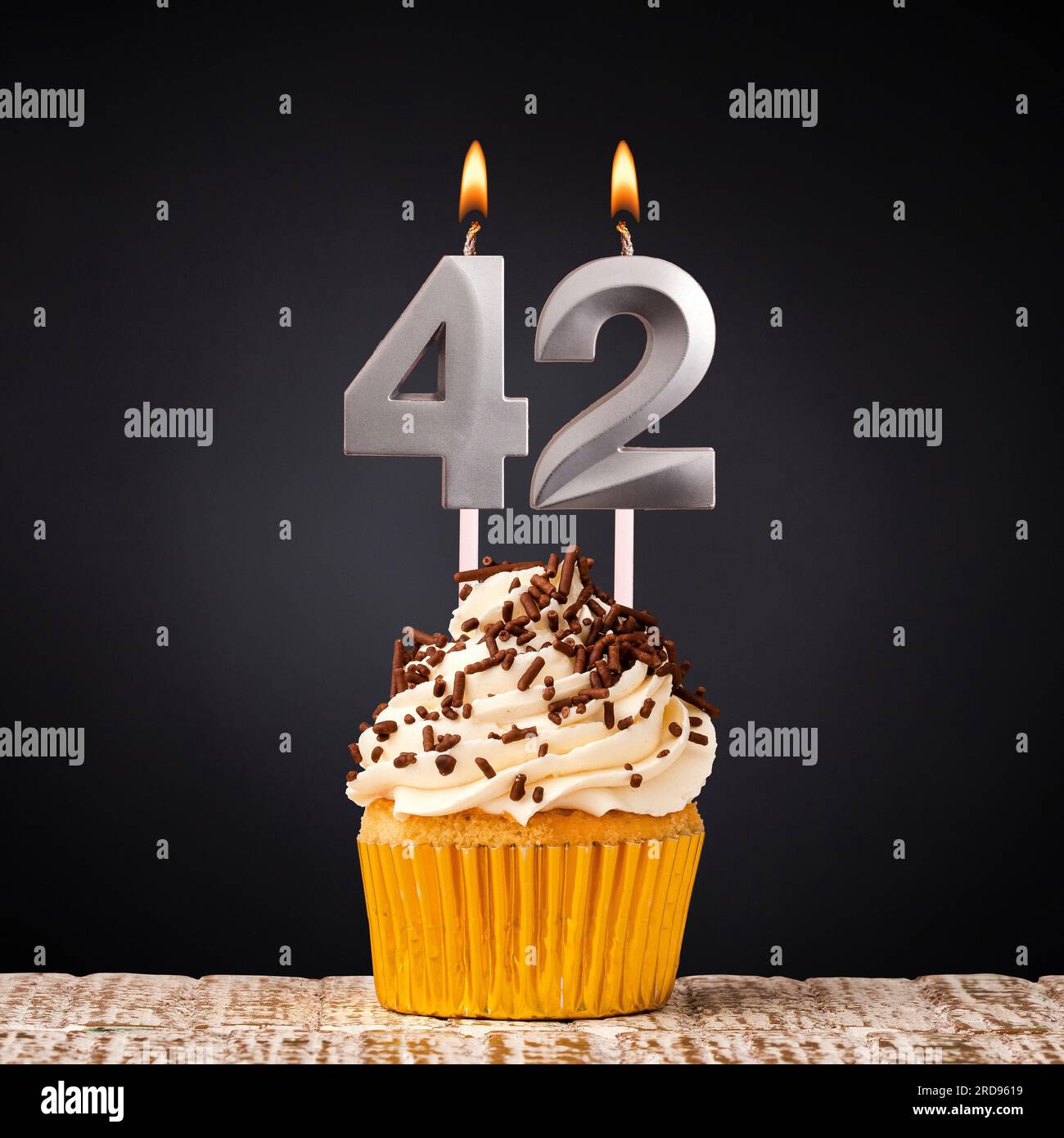 birthday cupcake with number 42 candle - Celebration on dark background ...