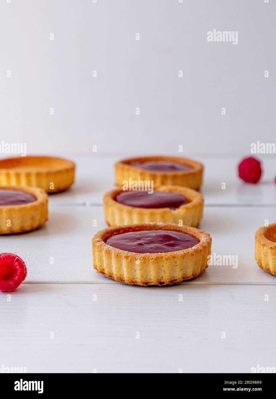 Small tartlets with raspberry filling Stock Photo - Alamy