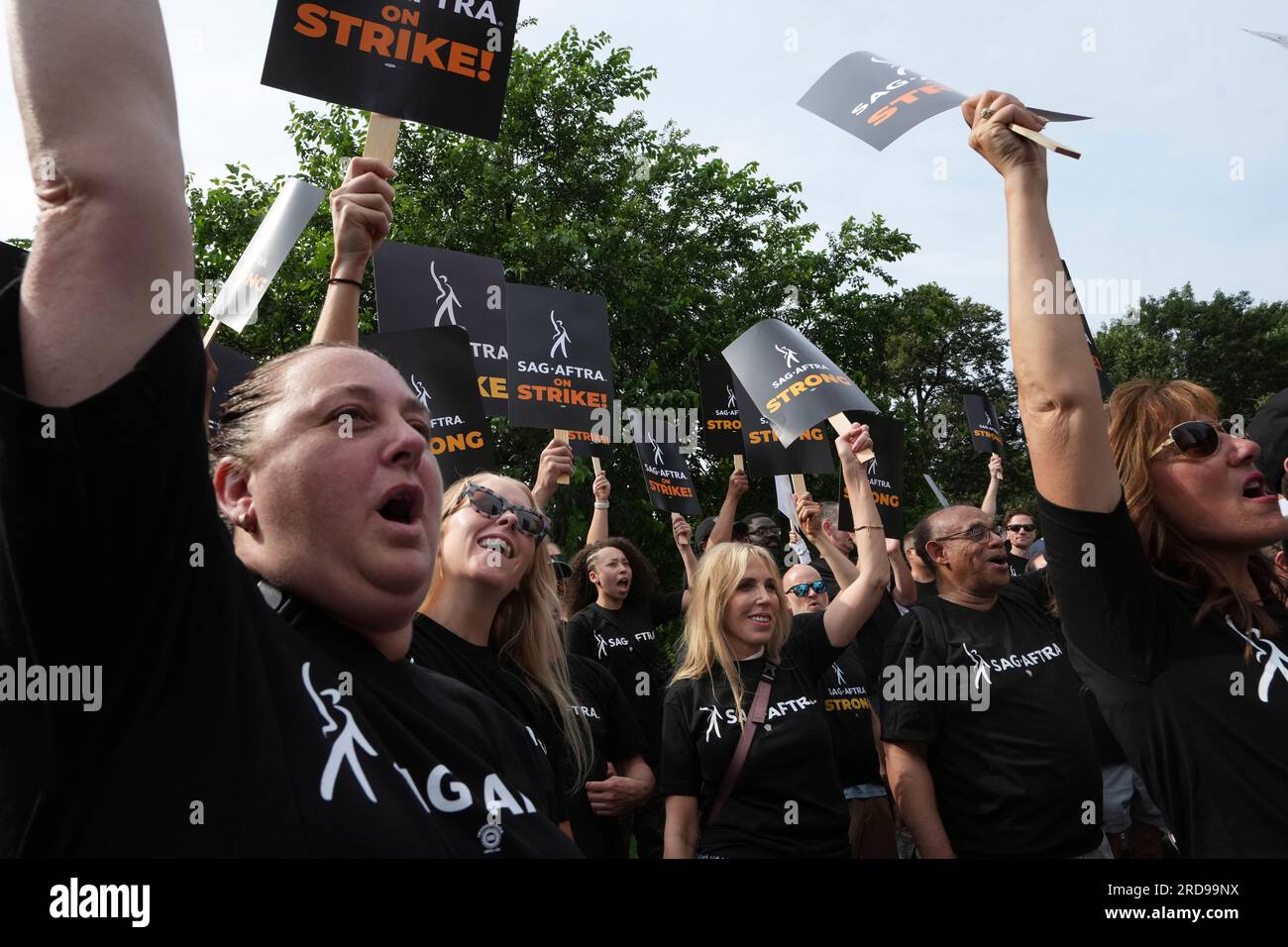 Striking film and television actors and supporters display signs and ...