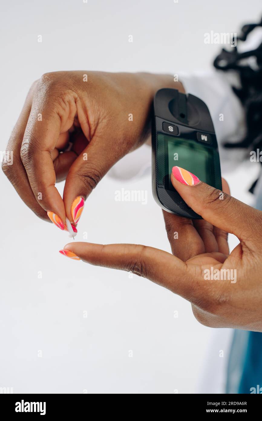 Doctor measuring blood sugar level of diabetic patient in clinic, self ...