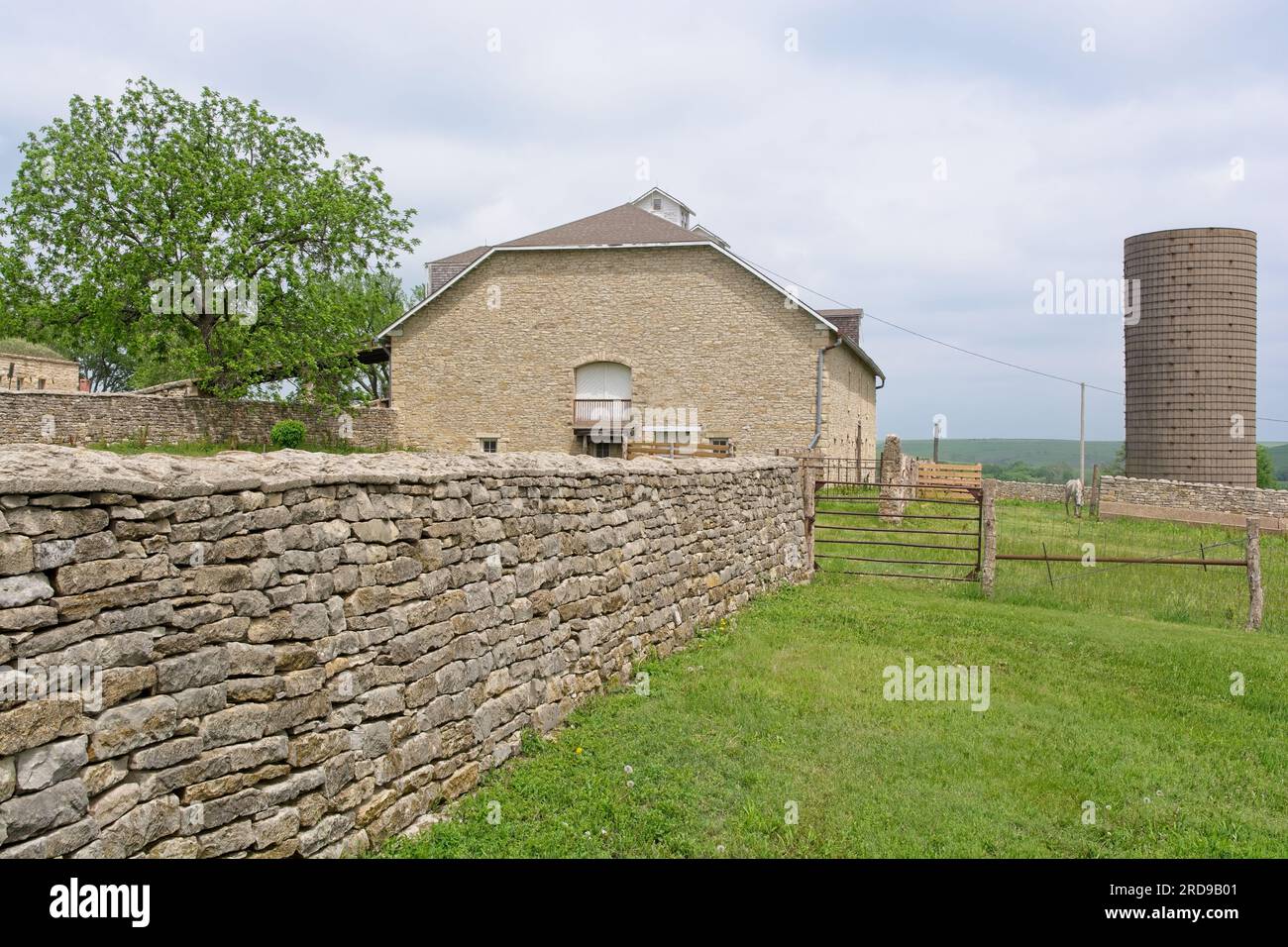 Limestone walls surround horse paddock and barn on Spring Hill Ranch on ...