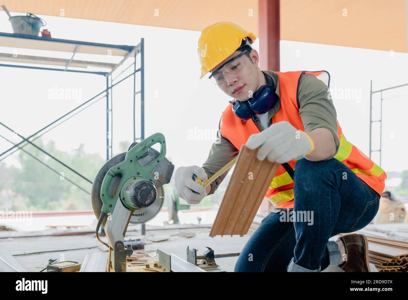 Structural worker dressed in safety gear and hard hat doing ...