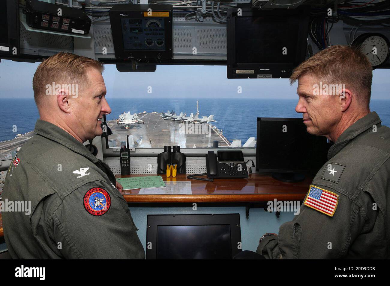 Capt. Rick Burgess, left, commanding officer of the world’s largest ...
