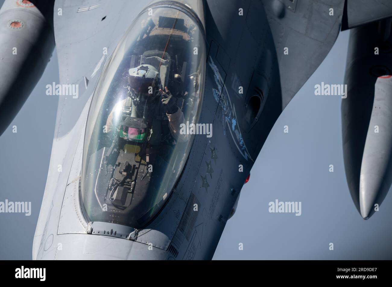 A U.S. Air Force F-16 Fighting Flacon pilot gestures towards a U.S. Air ...