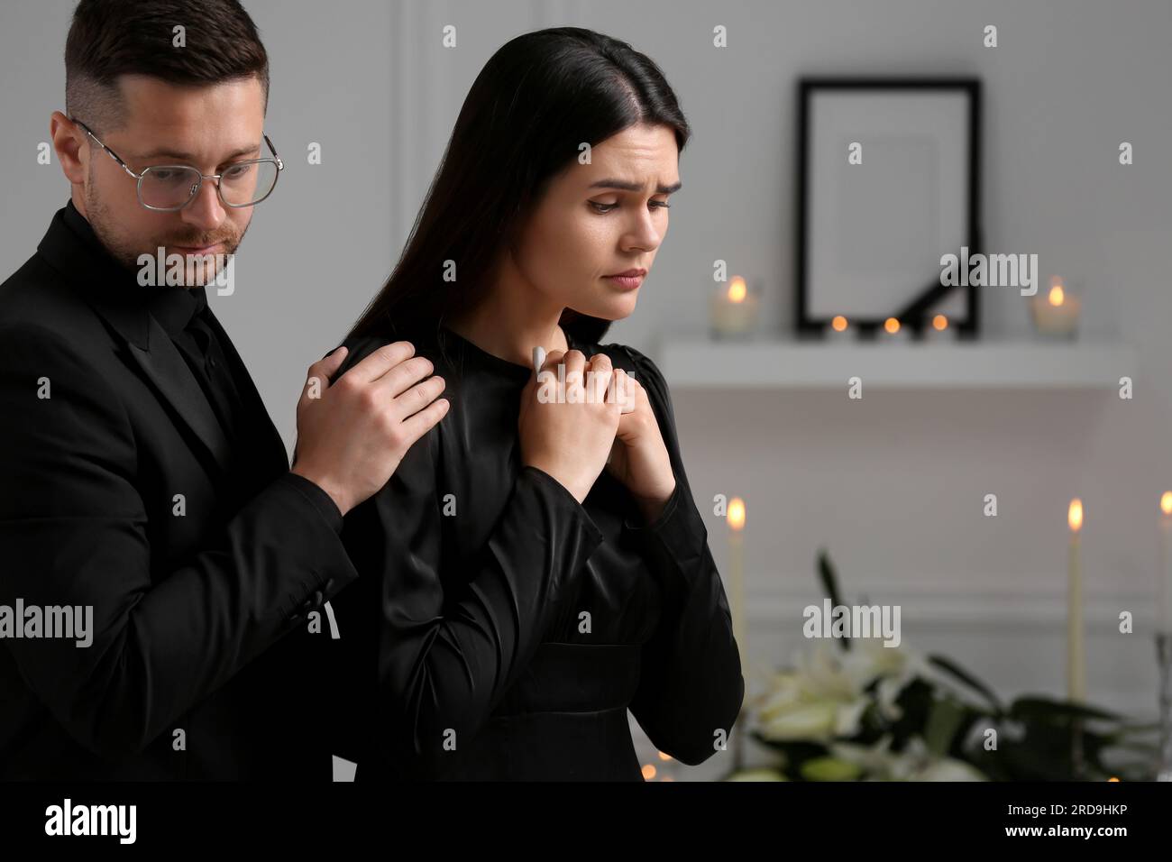Sad couple mourning indoors, space for text. Funeral ceremony Stock ...