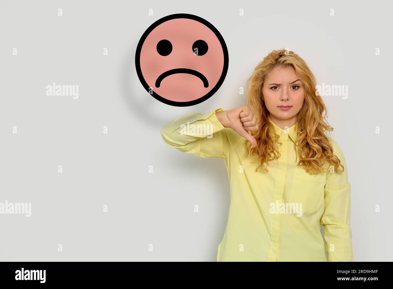 Complaint. Dissatisfied woman showing thumbs-down on white background ...