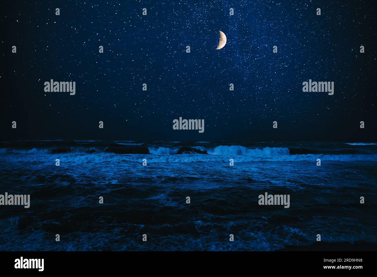 Crescent moon in starry sky over sea at night Stock Photo - Alamy