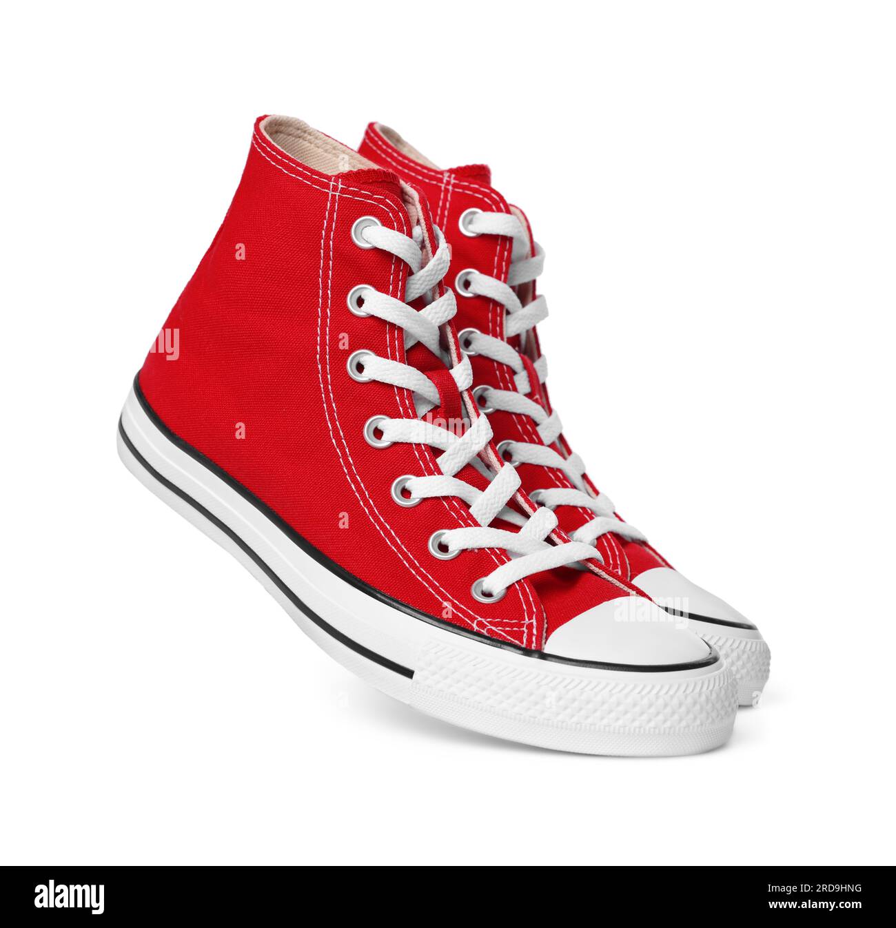 Pair of new red stylish high top plimsolls on white background Stock ...