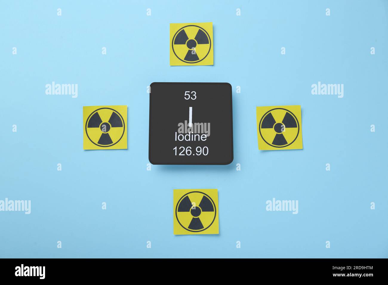 Card with chemical element Iodine and radiation signs on light blue ...